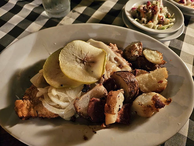 Chicken Berlin&mdash;where tender meat meets savory potatoes and a slice of apple that somehow makes perfect sense. It's like a German flavor puzzle solved on a plate.