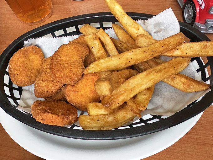 French fries that achieve that perfect balance between crispy and substantial, with chicken nuggets that remind you why simple food done right is unbeatable.