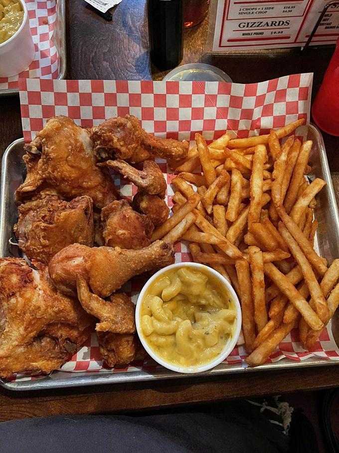 The holy trinity of comfort food: crispy chicken, golden fries, and mac and cheese that would make your grandmother simultaneously proud and jealous.