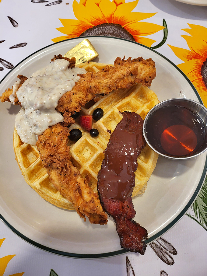 The holy trinity of breakfast indulgence: golden waffle, crispy chicken, and that glistening chocolate-dipped bacon. Breakfast or dessert? Yes, please.