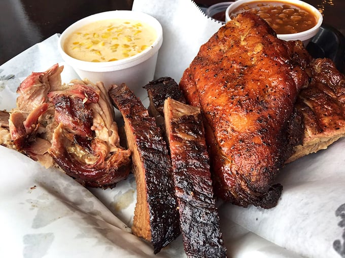 The holy trinity of BBQ&mdash;chicken, ribs, and pork&mdash;sharing space on butcher paper like old friends at a reunion. This isn't food; it's edible art.
