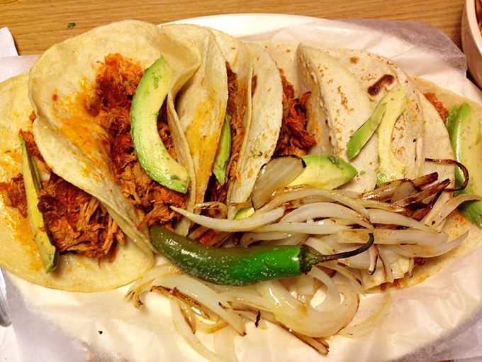 Three amigos of the taco world, dressed traditionally with diced onions and cilantro&mdash;no shredded lettuce or yellow cheese in this authentic lineup.