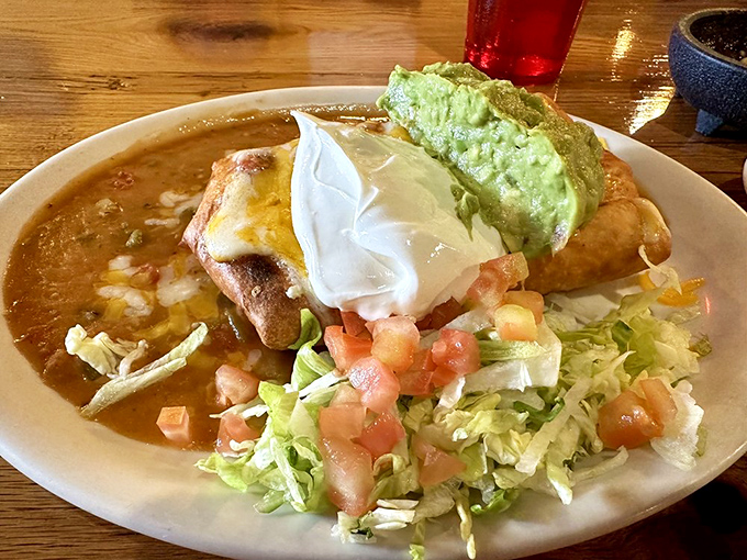 The chimichanga doesn't just arrive &ndash; it makes an entrance, smothered in sauce and accessorized with all the proper fixings like a celebrity on a red carpet.