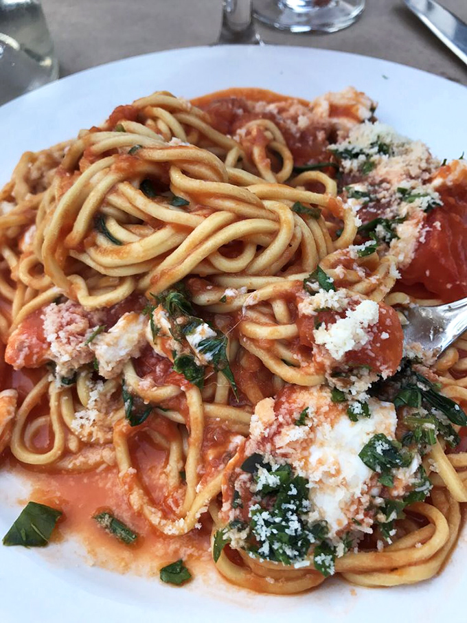 Chitarra spaghetti with its square-cut profile holds that tomato sauce like it was designed by Italian engineers specifically for this purpose.