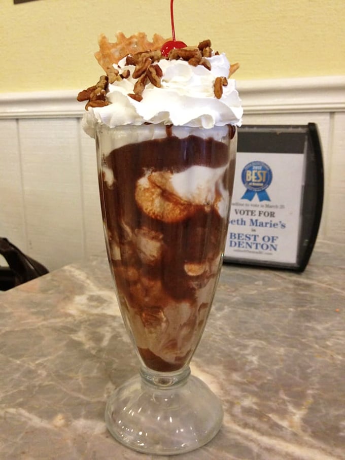 Layers of chocolate, whipped cream, and pecans create a skyscraper of sweetness that requires both engineering skills and appetite.