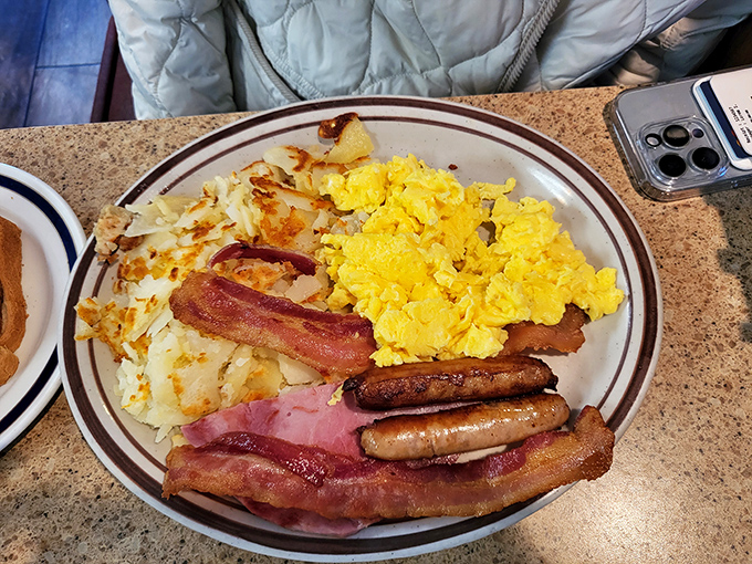 The breakfast plate that launched a thousand satisfied sighs. Eggs, bacon, sausage, and hash browns&mdash;the Mount Rushmore of morning meals. 