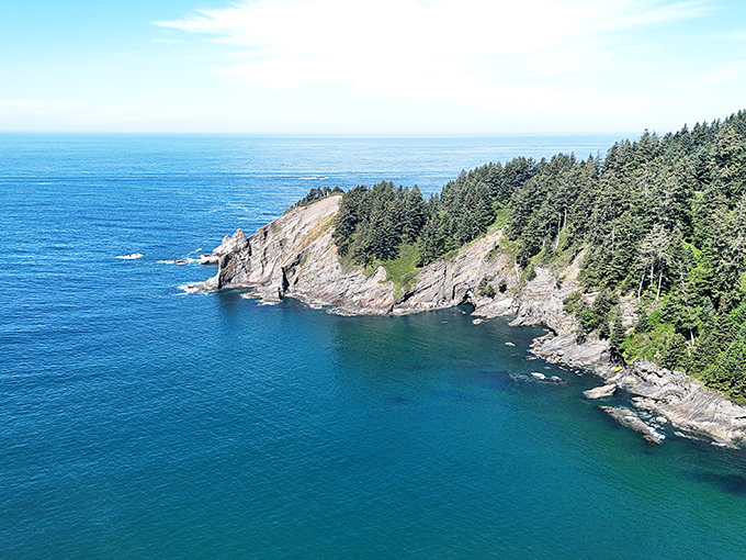 Rugged coastal cliffs stand sentinel over jade waters. Millions of years of geological drama creating the perfect backdrop for your afternoon nap.