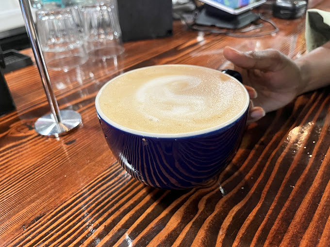 The humble blue mug cradles liquid gold&mdash;a creamy cortado that whispers sweet nothings to your taste buds with each sip.