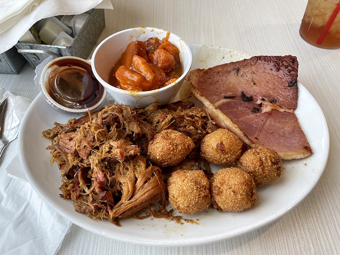 The combination plate that answers the eternal question, "Why choose between pulled pork and ham when you can have both?" Those hush puppies are the exclamation point.