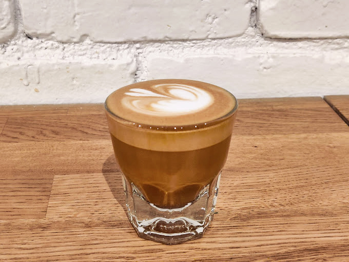 The cortado&mdash;that perfect middle ground between espresso and milk&mdash;served in a glass that lets you appreciate its golden gradient like a California sunset.
