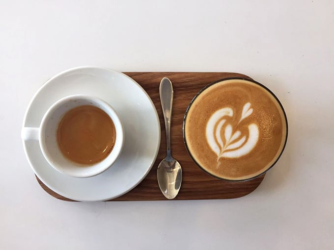 Espresso and milk dancing together on a wooden stage &ndash; this cortado presentation is what happens when coffee becomes performance art.