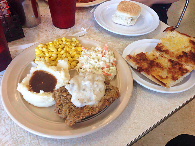 A plate that answers the eternal question: "How much comfort can fit in a 10-inch circle?" Mashed potatoes, country steak, and gravy uniting in harmony.