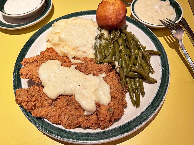 The holy trinity of Southern comfort: perfectly fried steak, creamy mashed potatoes, and green beans cooked with enough love to make vegetables exciting.
