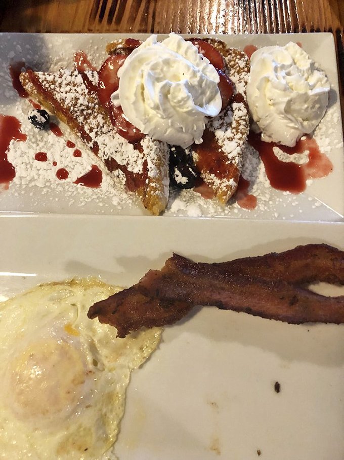 Golden-brown perfection with strawberries and cream creating a breakfast masterpiece. Michelangelo sculpted in marble; Oldwest sculpts in French toast.