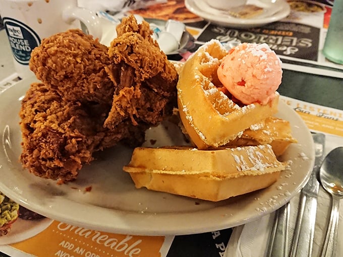 The holy trinity of breakfast: crispy chicken, fluffy waffles, and strawberry butter. Some people frame artwork; I'd frame this plate if it weren't so delicious.