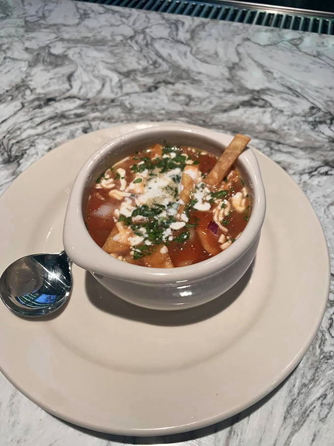 The humble crouton, now transformed into a flavor-soaked island in a sea of caramelized onion broth, waiting to be discovered.