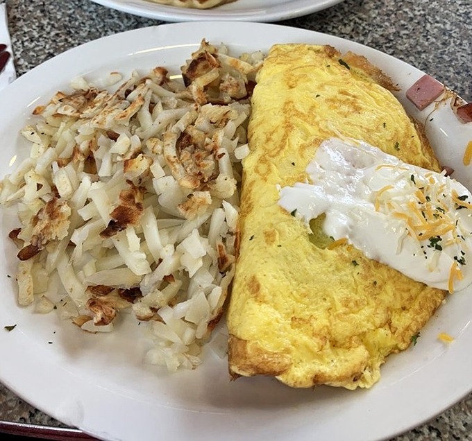 This Denver omelette isn't just breakfast&mdash;it's edible sunshine paired with hash browns crisped to such perfection they deserve their own fan club.