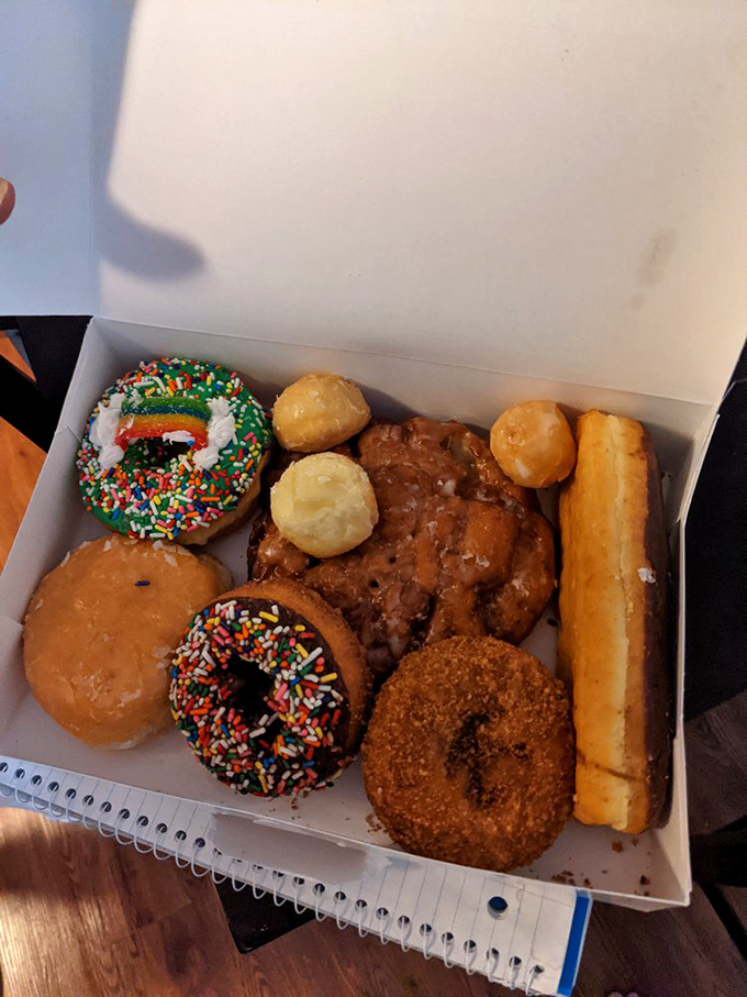 A box of possibilities: each donut represents a different pathway to happiness, but that apple fritter at the bottom is the expressway to bliss.
