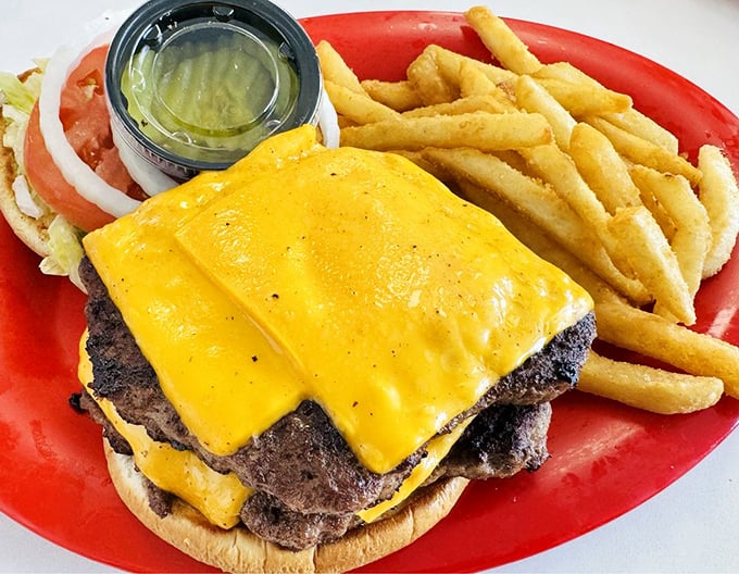 The cheeseburger that launched a thousand napkins. Two perfectly melted cheese slices blanket a hand-formed patty in this monument to American ingenuity.