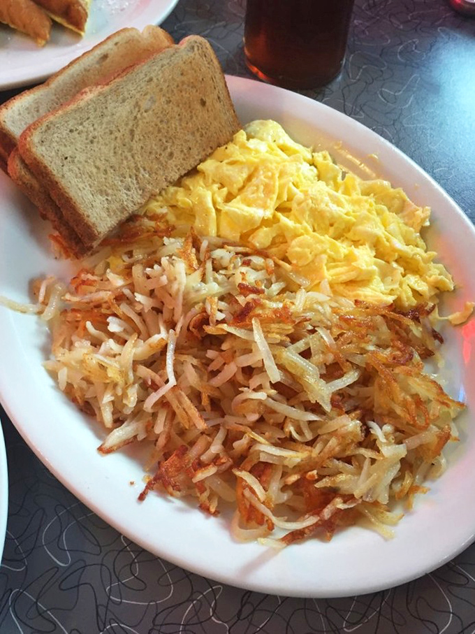 The golden ratio: perfectly scrambled eggs beside hash browns with that magical crisp-tender balance. Simple food done right is always the most satisfying.