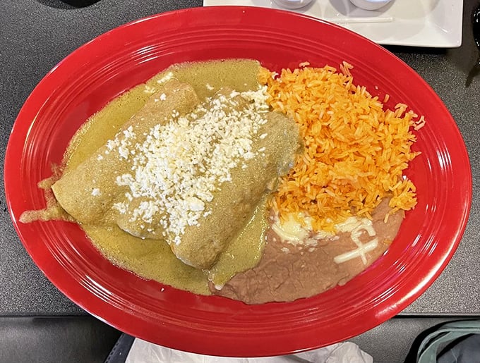 The enchilada trinity: perfectly rolled tortillas, sauce with actual depth, and that classic plate presentation that says, "Yes, this will absolutely fix whatever ails you."