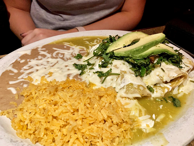 Enchiladas suizas that strike the perfect balance &ndash; creamy sauce, bright cilantro, and avocado slices that make everything in life better.