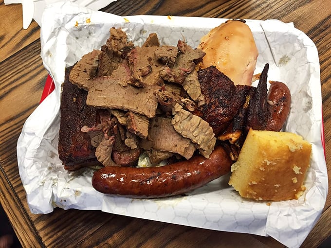 Barbecue's greatest hits album on a single tray. The cornbread is just there to remind you that vegetables once existed.