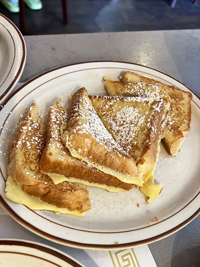 Golden-brown French toast that's achieved that mythical balance&mdash;crispy edges, custardy center. The powdered sugar is just showing off at this point.