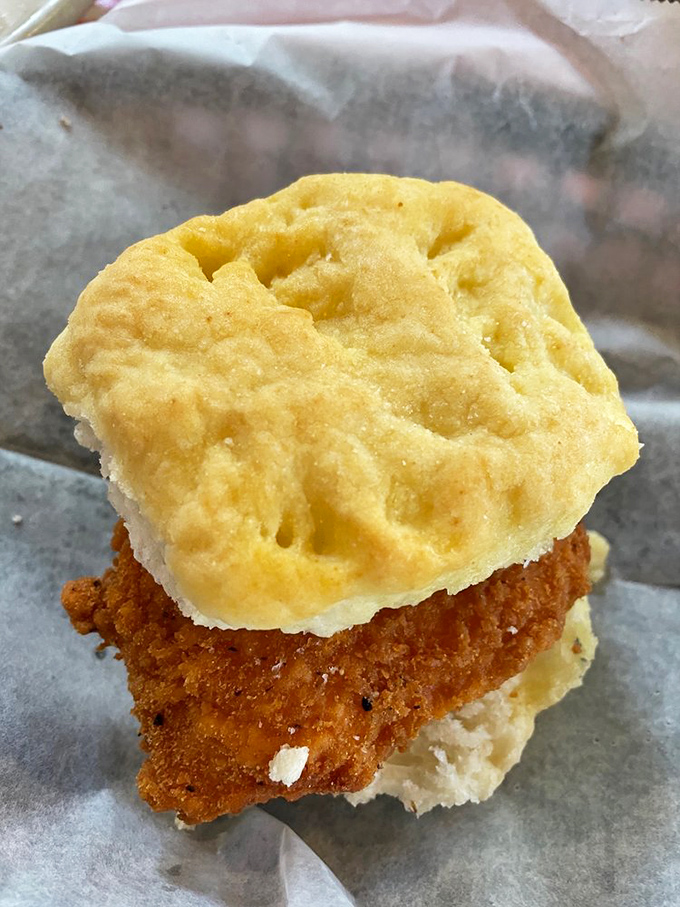The biscuit sandwich that launched a thousand food cravings&mdash;crispy Cajun-spiced chicken nestled between cloud-like biscuit halves that practically demand a midday nap afterward.