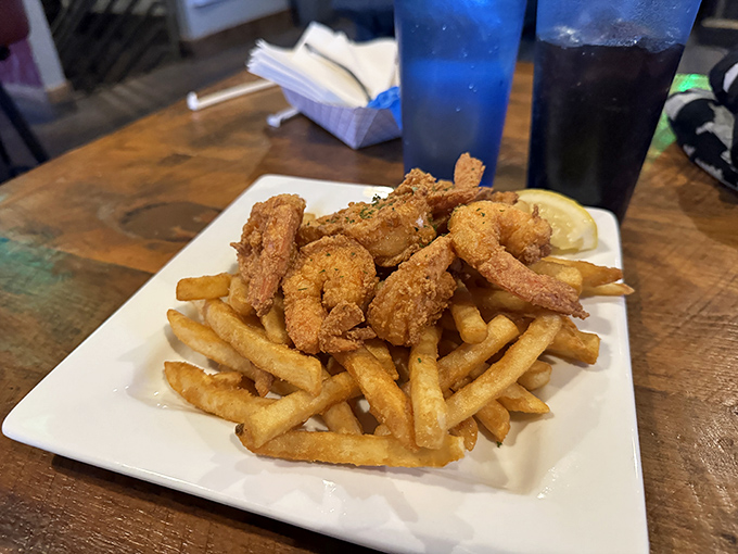 Golden-fried shrimp perch atop perfectly crisp fries&mdash;proof that sometimes the simplest pleasures deliver the most profound satisfaction.
