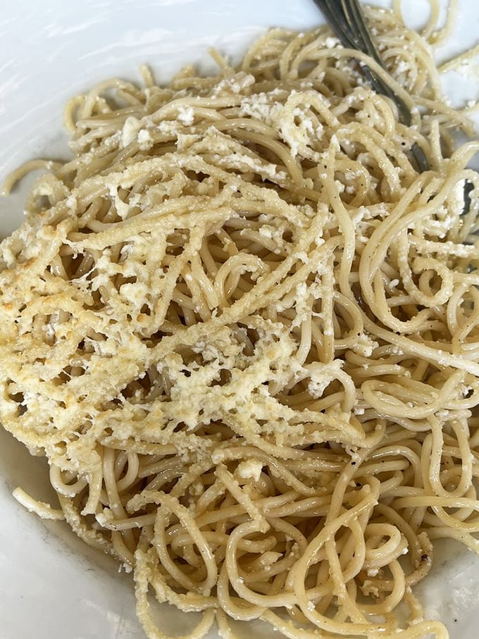 Greek spaghetti with a snowfall of cheese that transforms simple pasta into something your Italian grandmother would secretly approve of.
