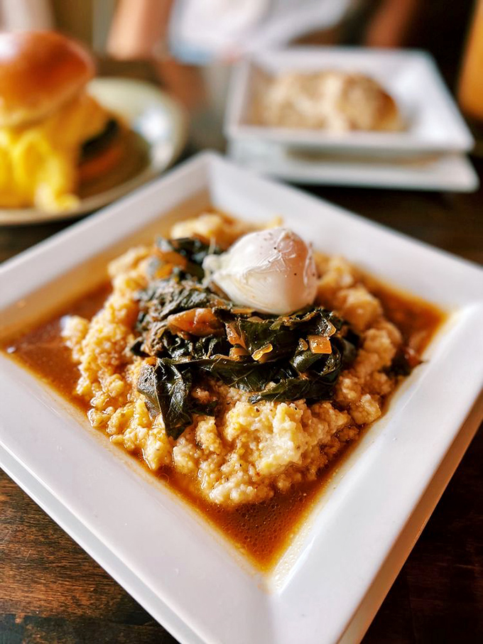 Southern comfort meets Midwest soul in this bowl of greens and grits, topped with what appears to be a poached egg of dreams.