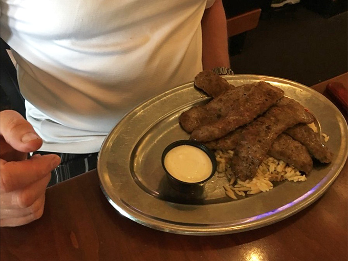 Perfectly seasoned meat resting on a bed of rice&mdash;proof that sometimes the simplest meals deliver the most profound satisfaction.