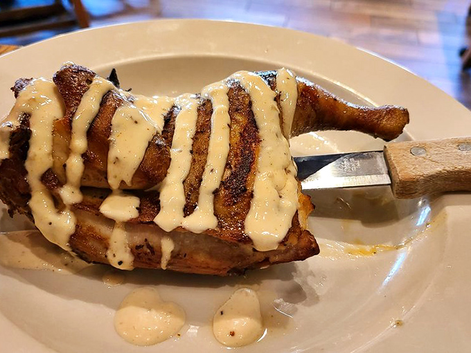 Smoke-kissed chicken drizzled with sauce that would make angels weep. The kind of dish that makes you seriously consider licking the plate.