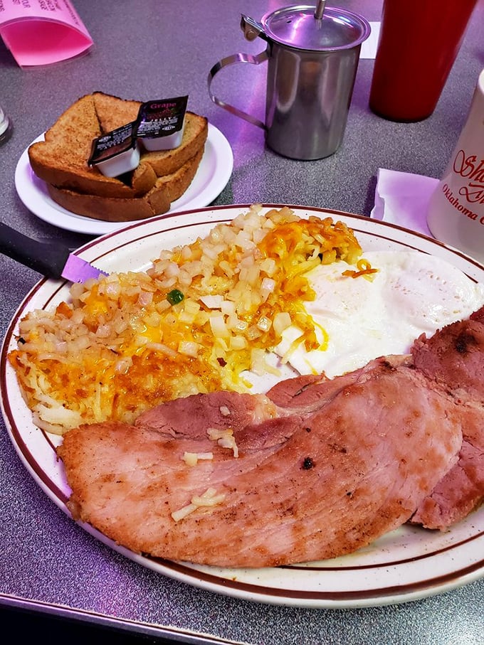 Ham that's been kissed by the griddle pairs with eggs and cheese-topped hash browns&mdash;a plate that says "good morning" better than words ever could. 