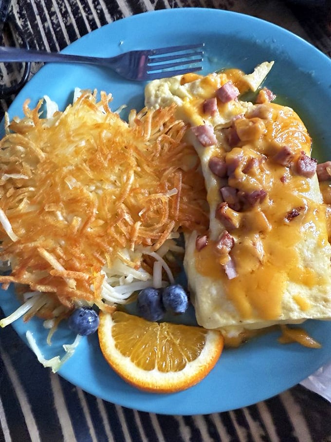 This isn't just any ham and cheddar omelet&mdash;it's a cheese-draped masterpiece with hash browns so perfectly crispy they deserve their own fan club.