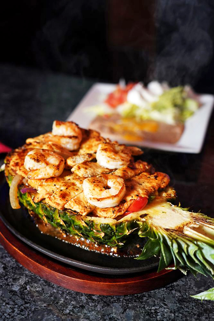 Nature's most perfect serving dish meets perfectly seasoned shrimp. When pineapple boats arrive tableside, you know you're in for some serious flavor sailing.