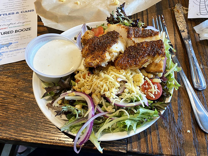 Even salads get the star treatment here. That blackened fish perched atop fresh greens is the celebrity cameo in a veggie blockbuster.