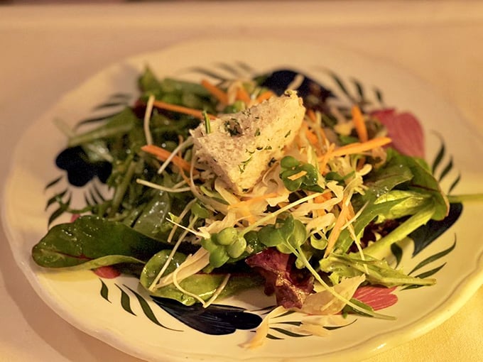 A garden on a plate! This vibrant salad with its crisp greens and delicate Parmesan crisp proves that sometimes the simplest dishes require the most care.