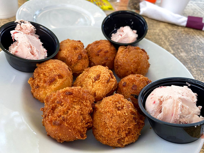 Golden-brown hush puppies so perfectly fried they'd make your Southern grandmother weep with pride. The dipping sauce is just showing off.