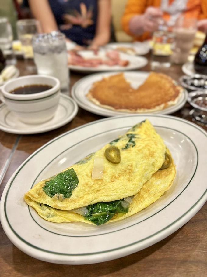 An omelet that knows how to dress for the occasion—spinach for health, olives for sophistication, and enough cheese to make Wisconsin proud.