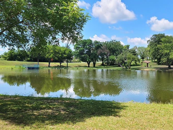 Johnstone Park's serene pond reflects Oklahoma's big sky, offering a peaceful respite where nature and small-town life find perfect harmony.