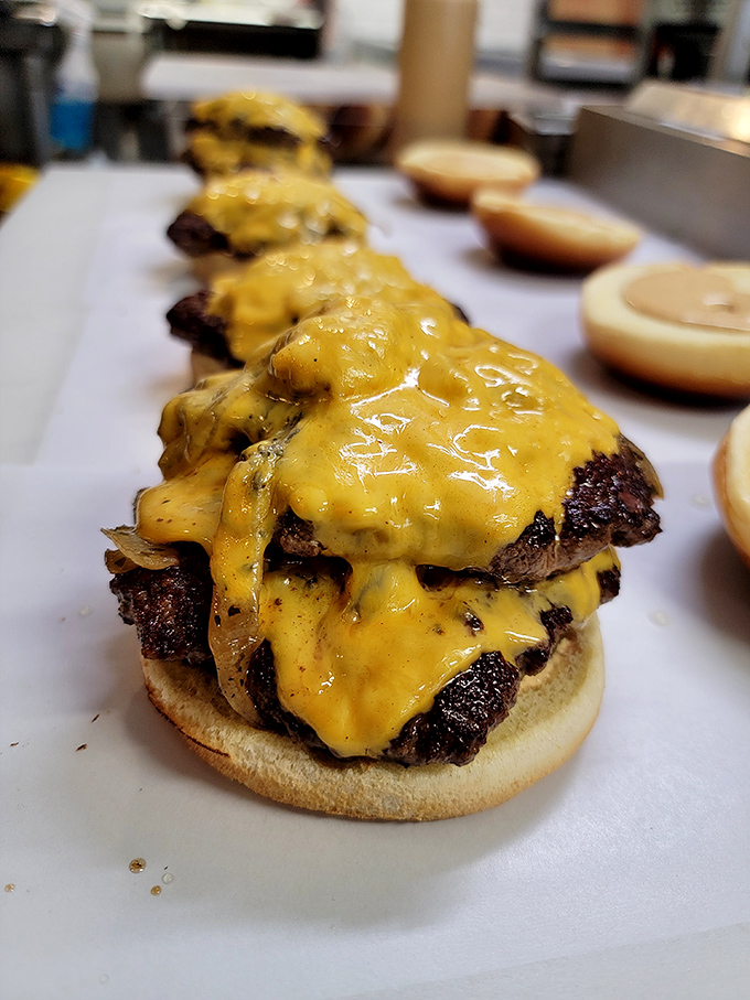 Assembly line of joy&mdash;these patties getting their cheese blankets before meeting their destiny in someone's happy stomach. 