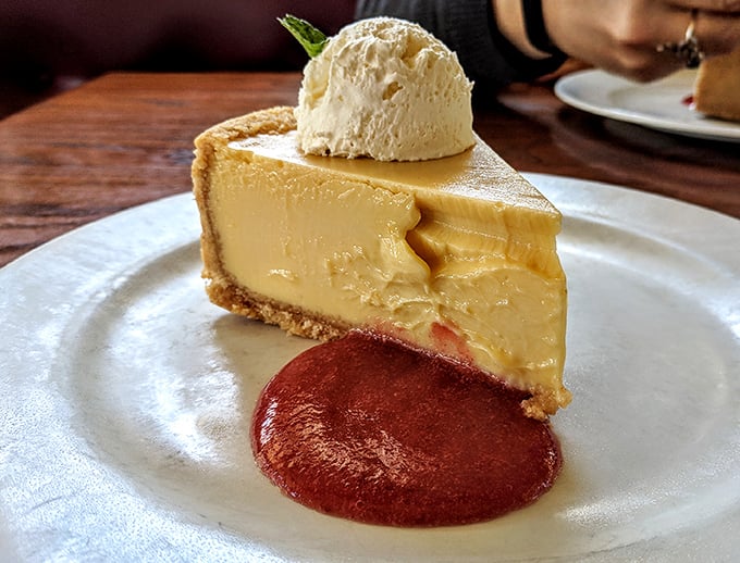 A buttery graham cracker crust cradles that sunshine-yellow filling like it's protecting the culinary crown jewels of the Outer Banks.