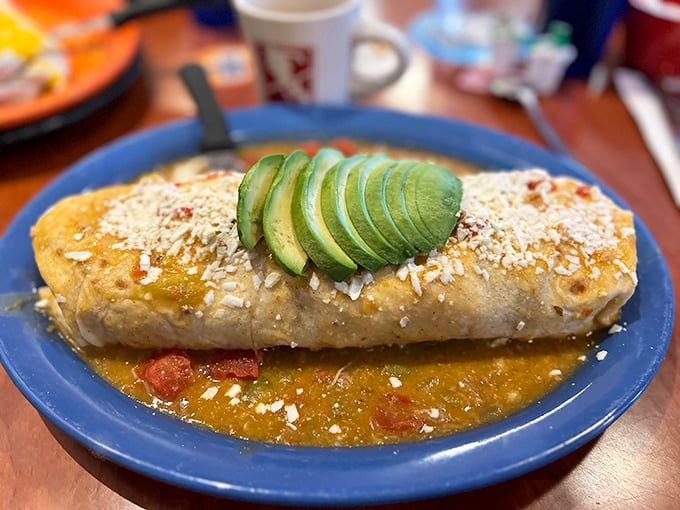 Not so much a burrito as an edible work of art, topped with fresh avocado and swimming in that legendary green chili sauce.
