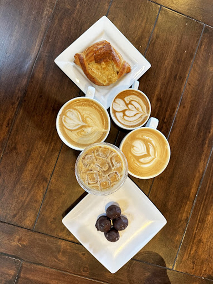 The holy quartet: artisanal pastry, chocolate truffles, and coffee with latte art so pretty you almost feel guilty destroying it. Almost.