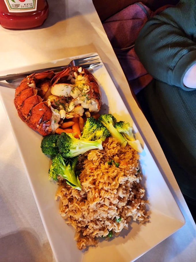 Lobster tail perched majestically alongside colorful vegetables and rice. Ocean royalty making a grand appearance in the Midwest.