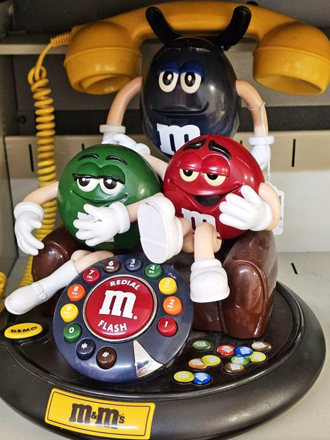 The M&M gang lounging on a retro telephone &ndash; when candy characters had landlines and your calls were sweeter.