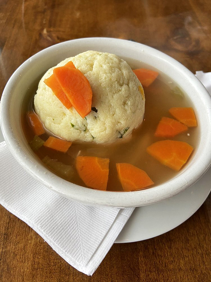 This soup isn't just food; it's therapy in a bowl. The vegetables add color, but that matzo ball is the undisputed heavyweight champion.