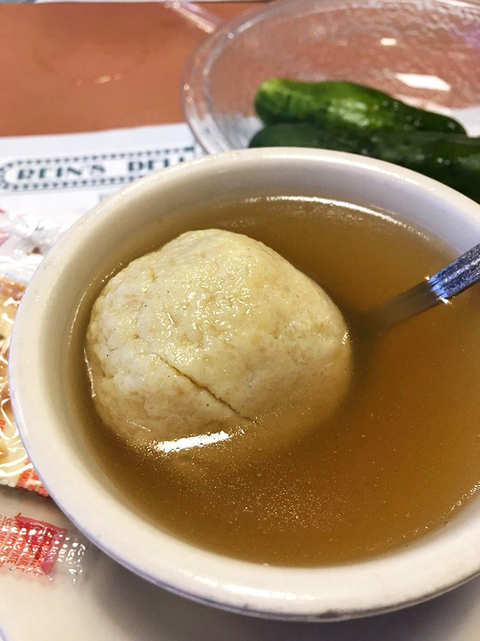 A spoon poised for action over this matzo ball soup&mdash;the universal sign for "conversation pause while I savor this moment of perfection."